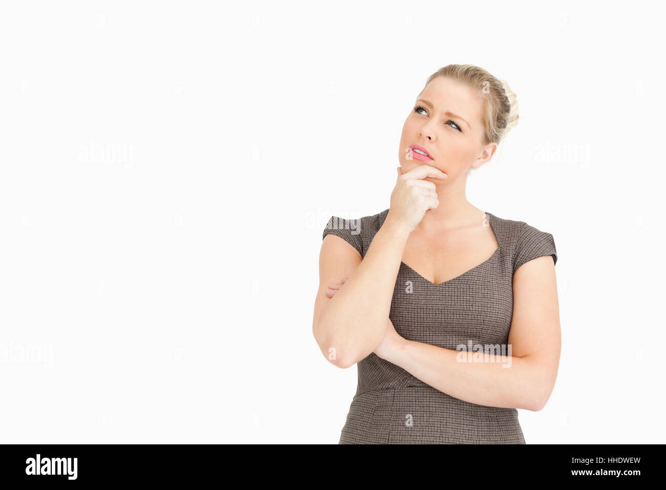 Woman thinking with a finger on her face against white background Stock ...