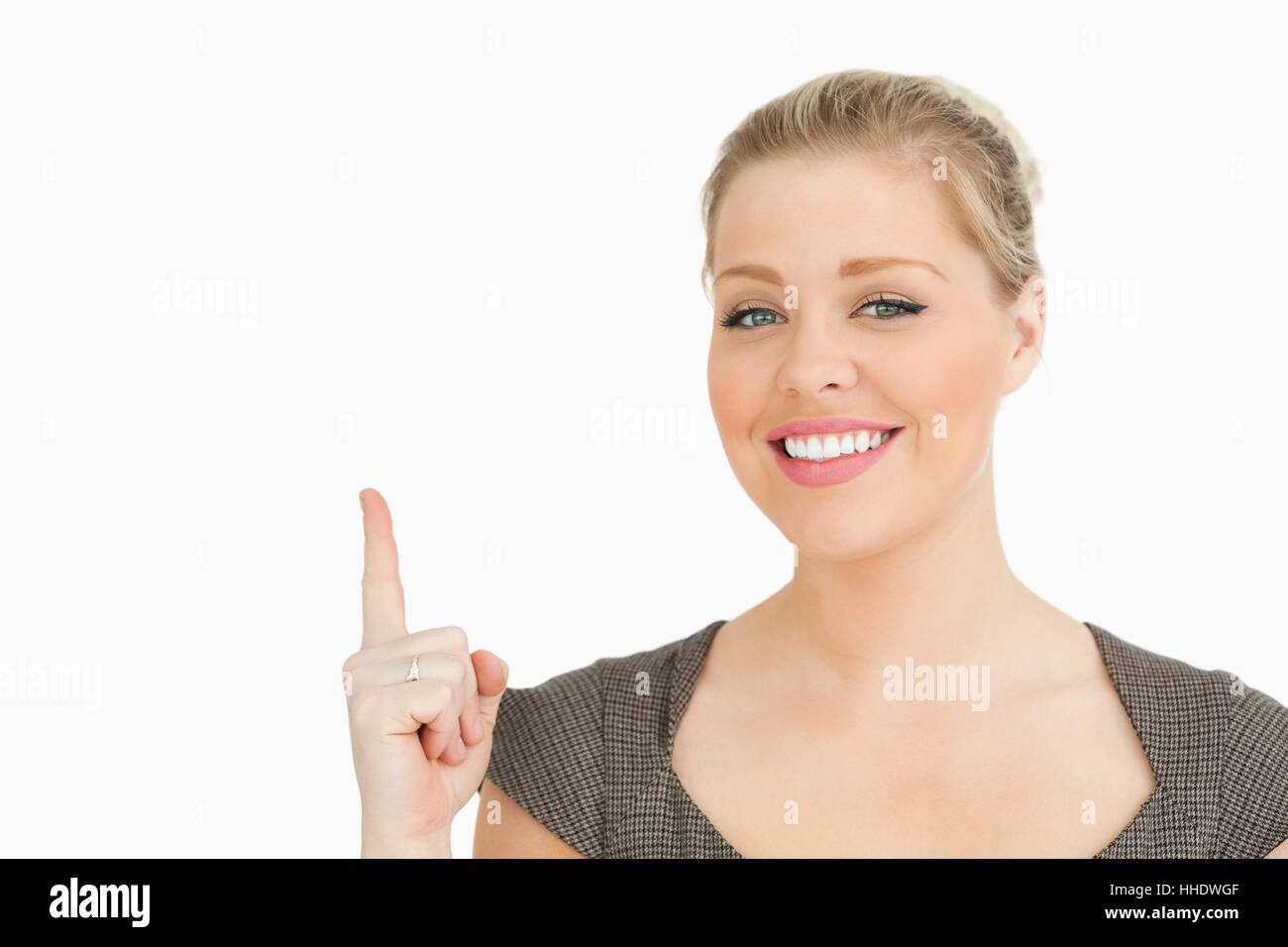 Woman smiling pointing something against white background Stock Photo ...