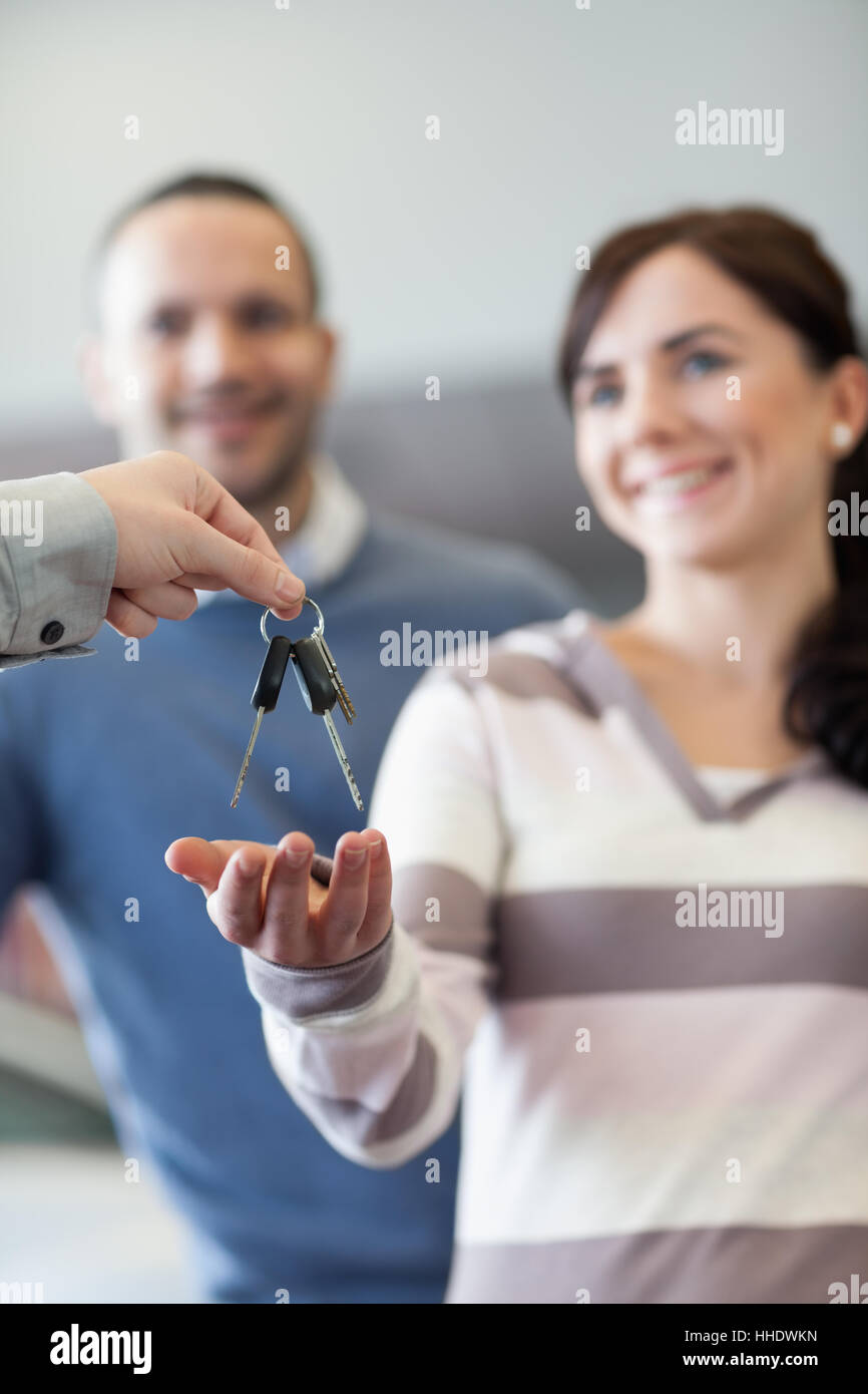 Couple receiving keys in a car shop Stock Photo - Alamy