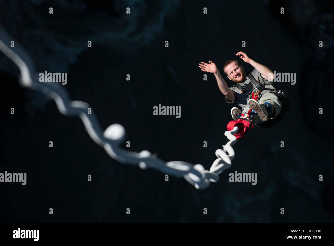 A man smiles for the camera as he is bounced back up during a Bungee ...