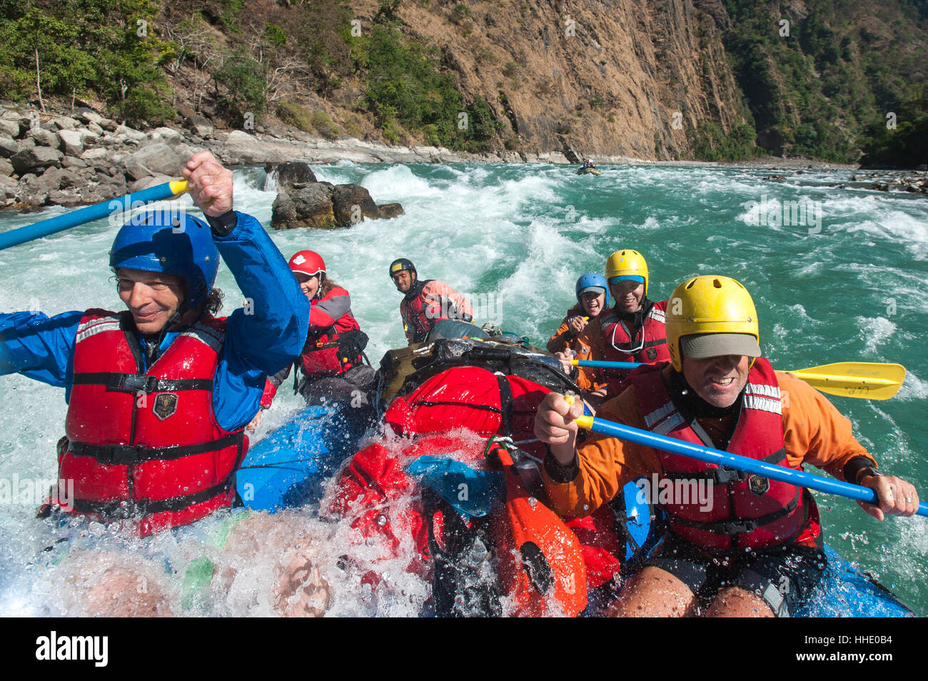 Rafters get splashed as they go through some big rapids on the Karnali ...
