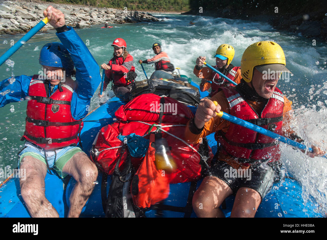 Rafters get splashed as they go through some big rapids on the Karnali ...