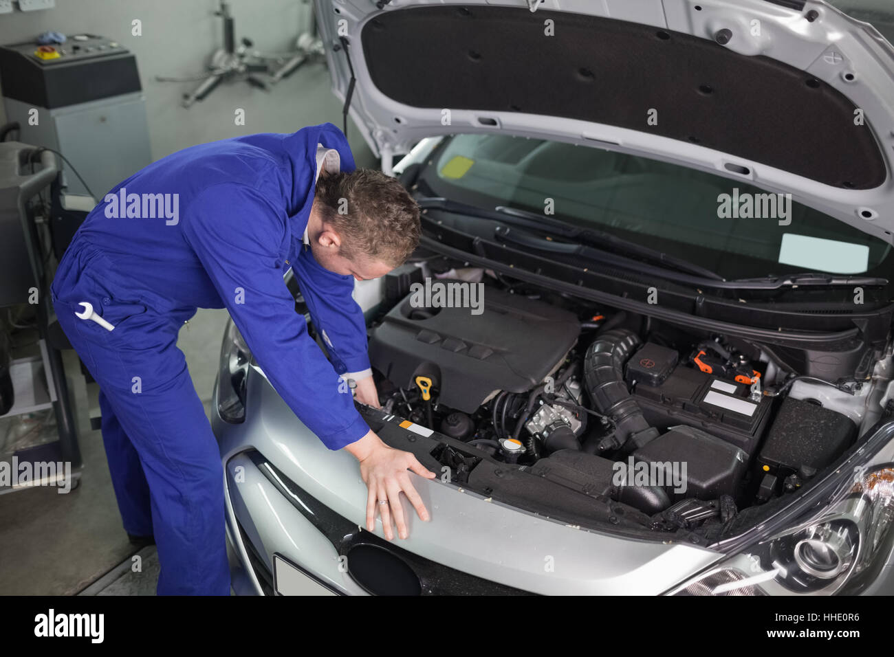Mechanic repairing an engine in a garage Stock Photo - Alamy