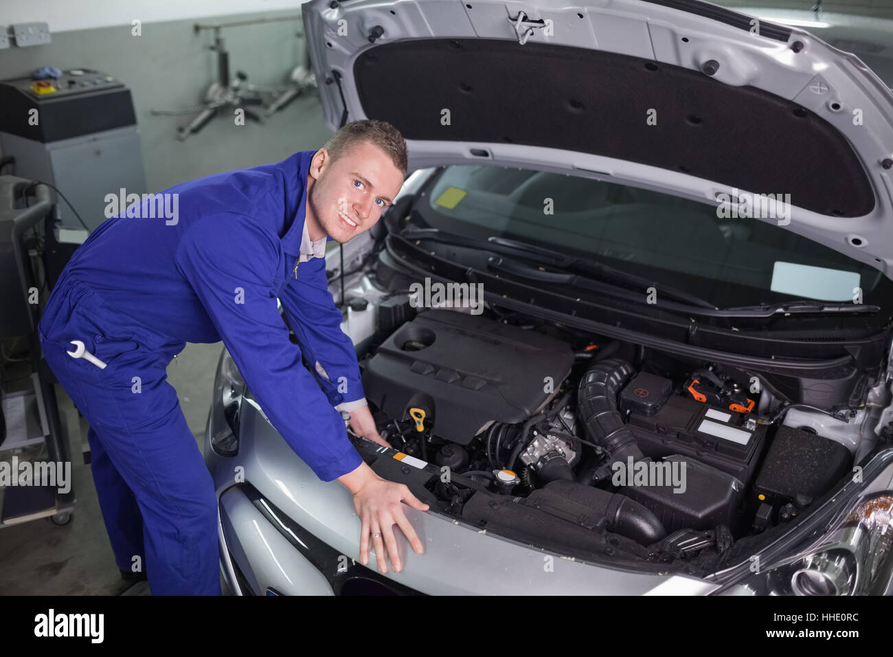 Mechanic repairing an engine of car in a garage Stock Photo - Alamy
