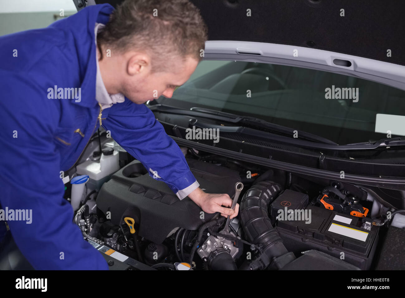 Mechanic repairing the engine with a spanner in a garage Stock Photo ...