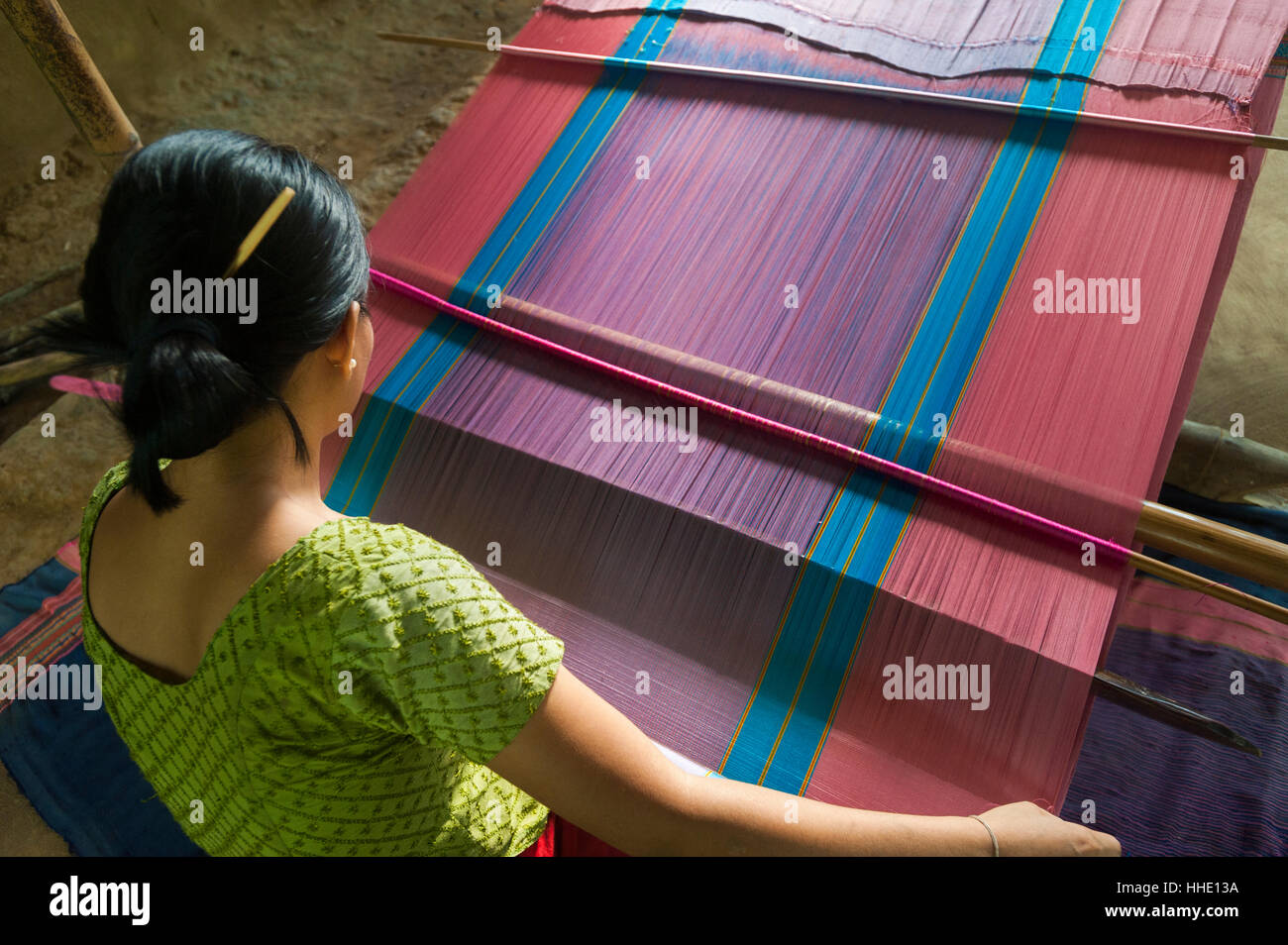 A woman weaves traditional clothes using a hand loom, Chittagong Hill ...