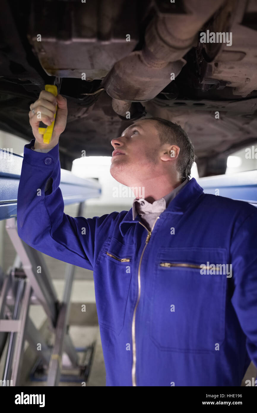 Mechanic repairing with an adjustable pliers in a garage Stock Photo ...