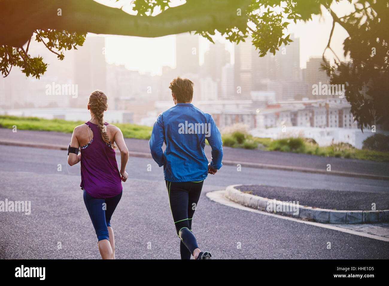 Runner couple running on urban city street Stock Photo - Alamy