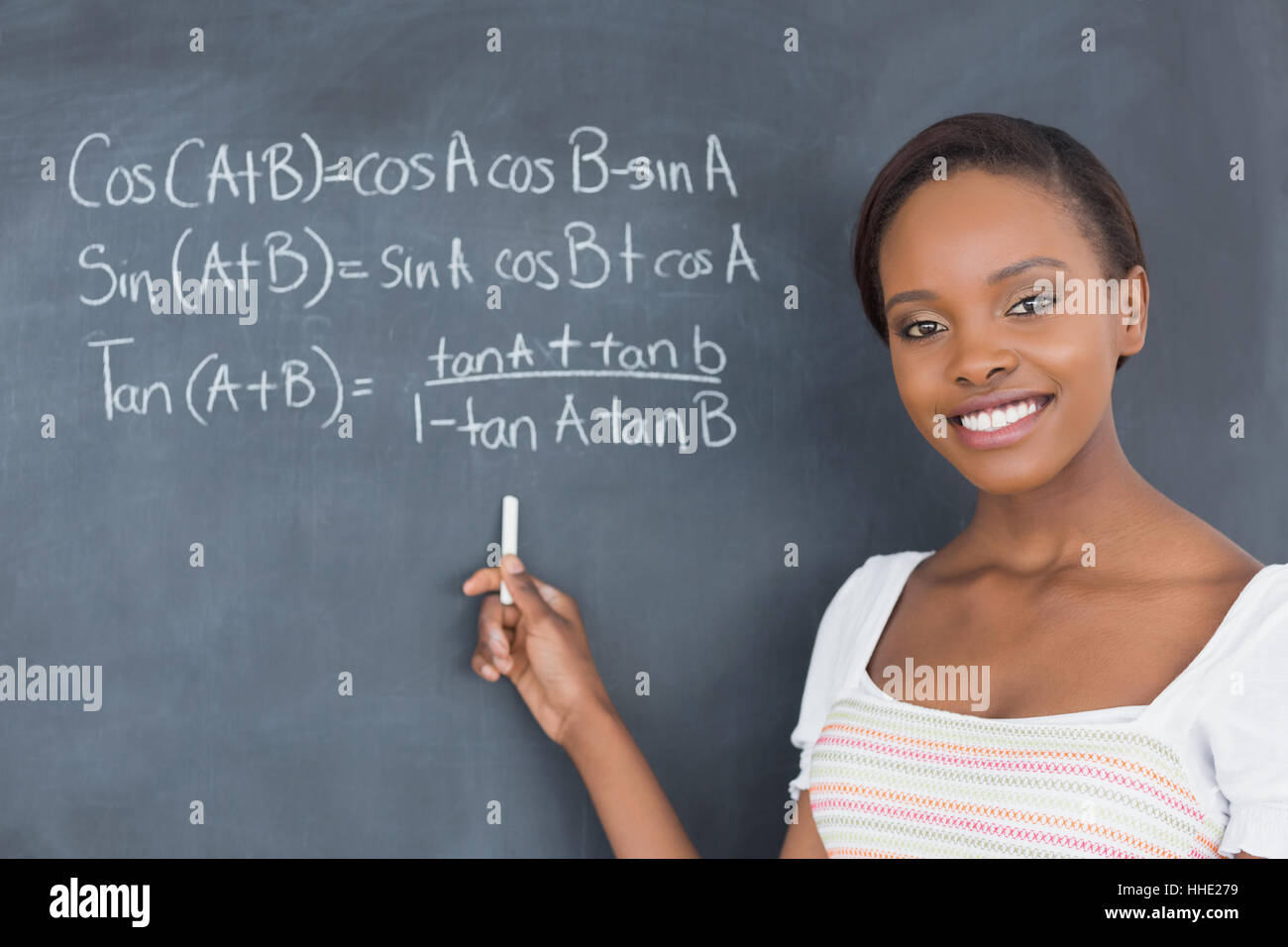 Student showing a blackboard in a classroom Stock Photo - Alamy
