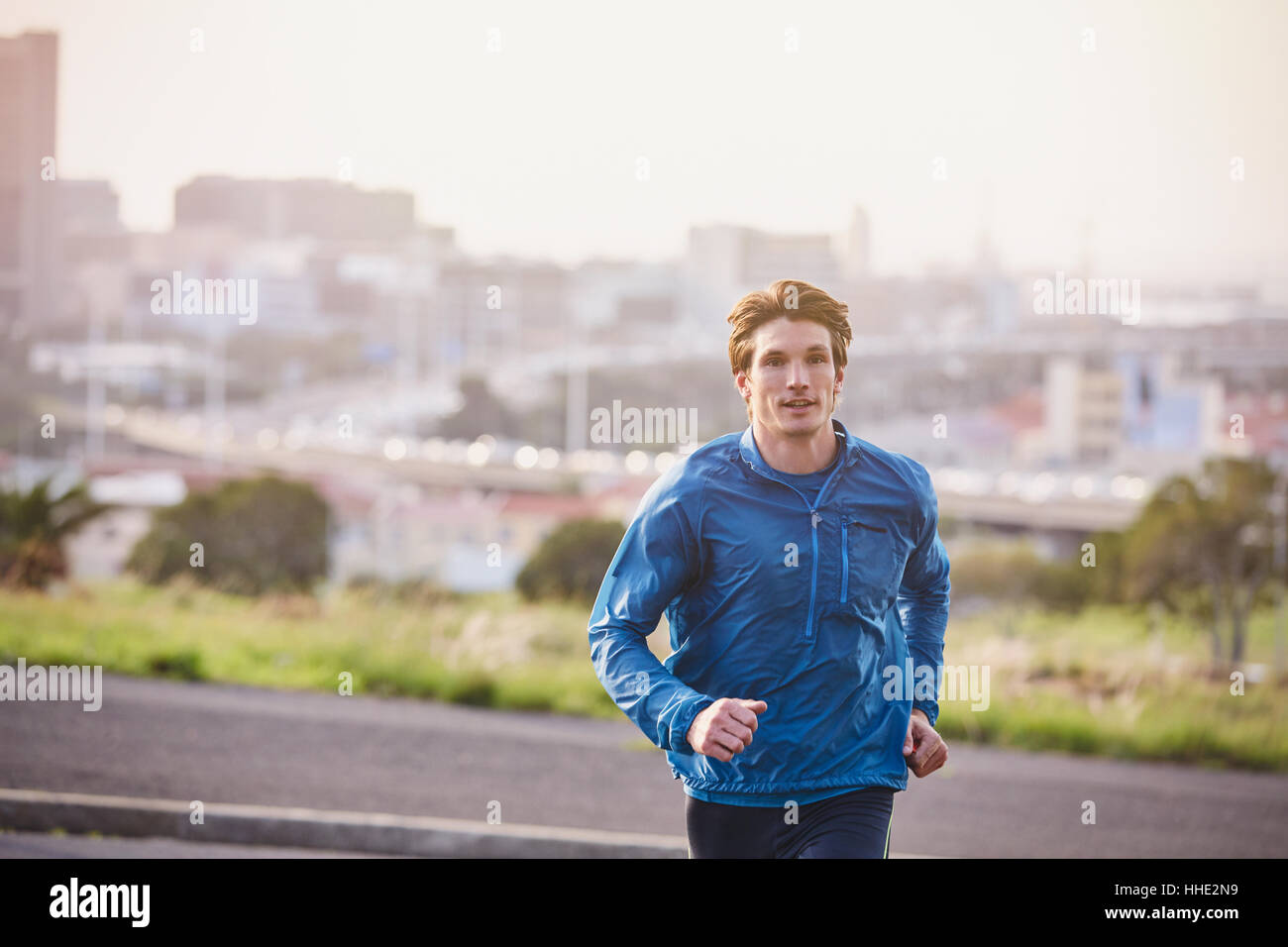 Male runner running on urban city street Stock Photo - Alamy