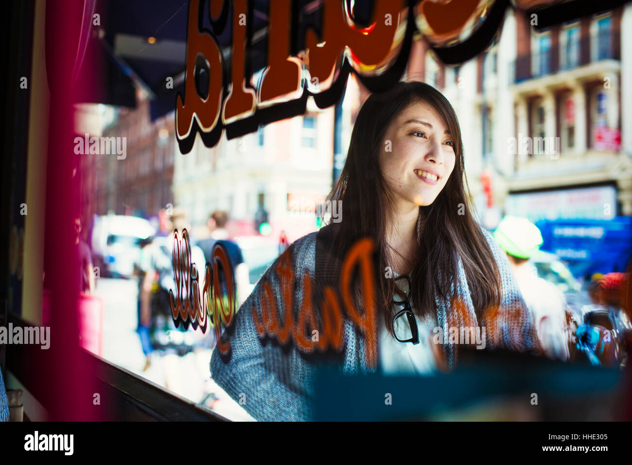 Woman walking past window display hi-res stock photography and images ...