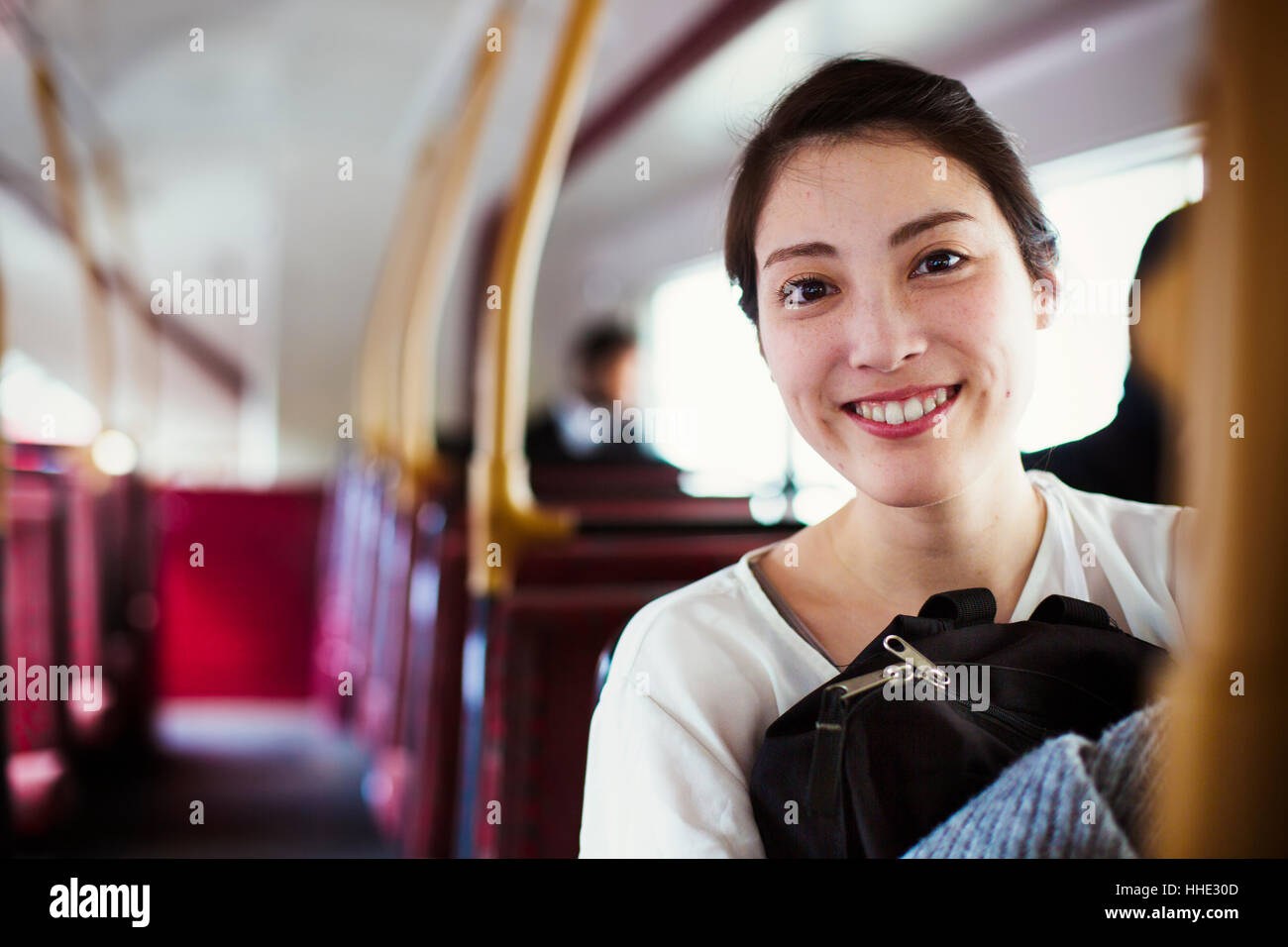 Young Japanese woman enjoying a day out in London, riding on a double ...