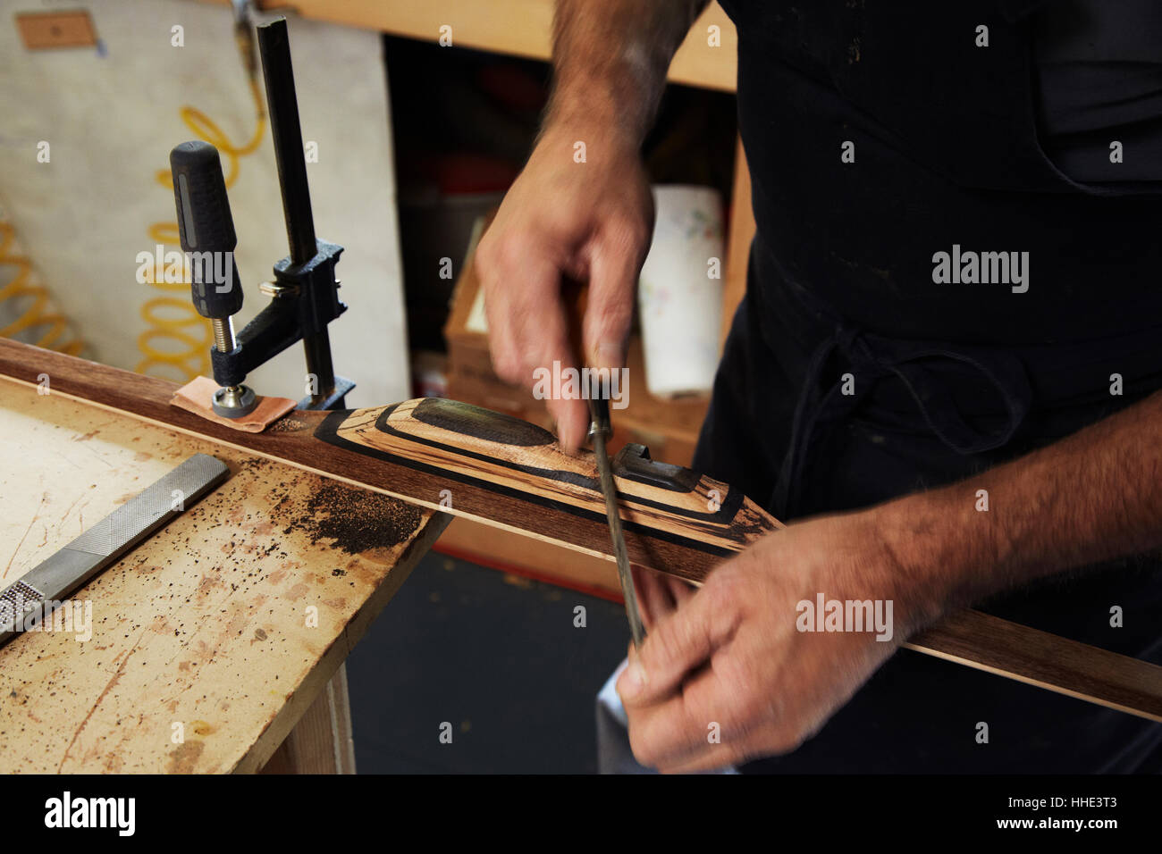 A bowman, a skilled man making a bow, in his workshop Stock Photo - Alamy