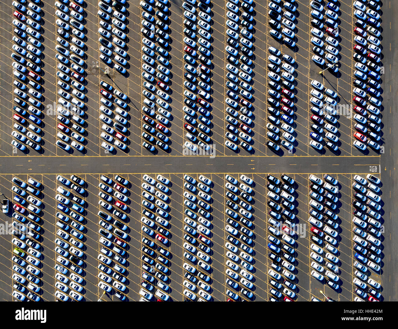Aerial view of a car distribution centre, new cars parked in rows on a ...