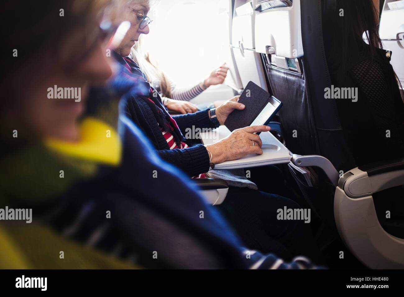 A passenger on an aircraft using a smart phone Stock Photo - Alamy