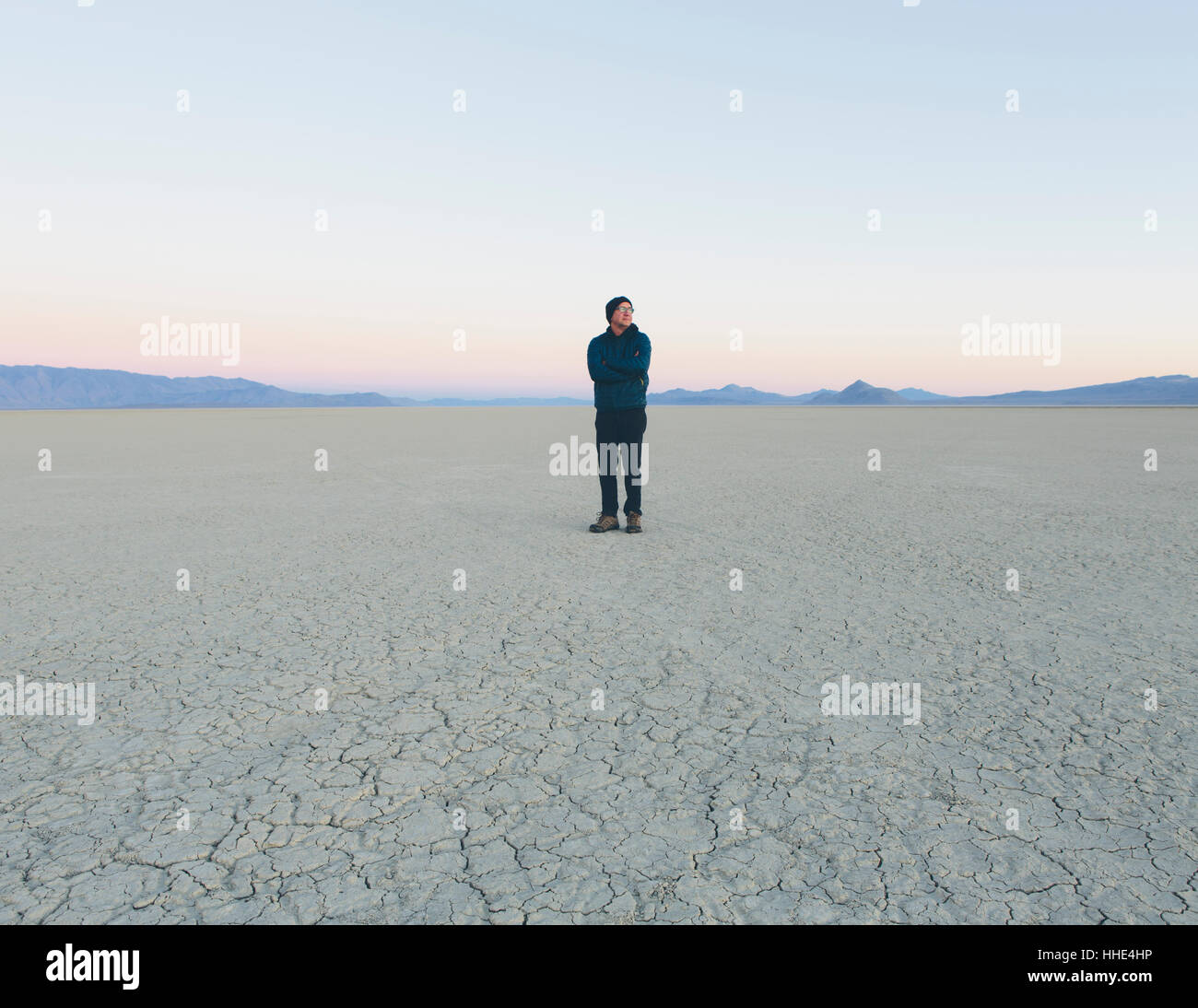 Man standing in vast desert playa at dawn, Black Rock Desert, Nevada ...