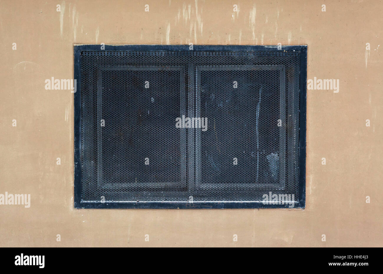 Details of a small house window covered with metal net Stock Photo - Alamy