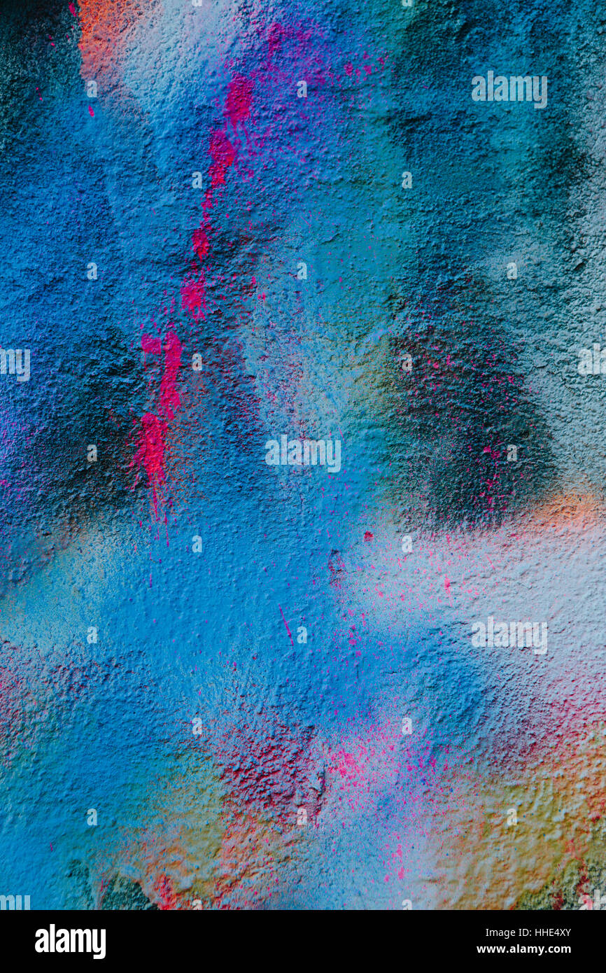 A wall daubed with colourful paint, graffiti, street art, close up ...