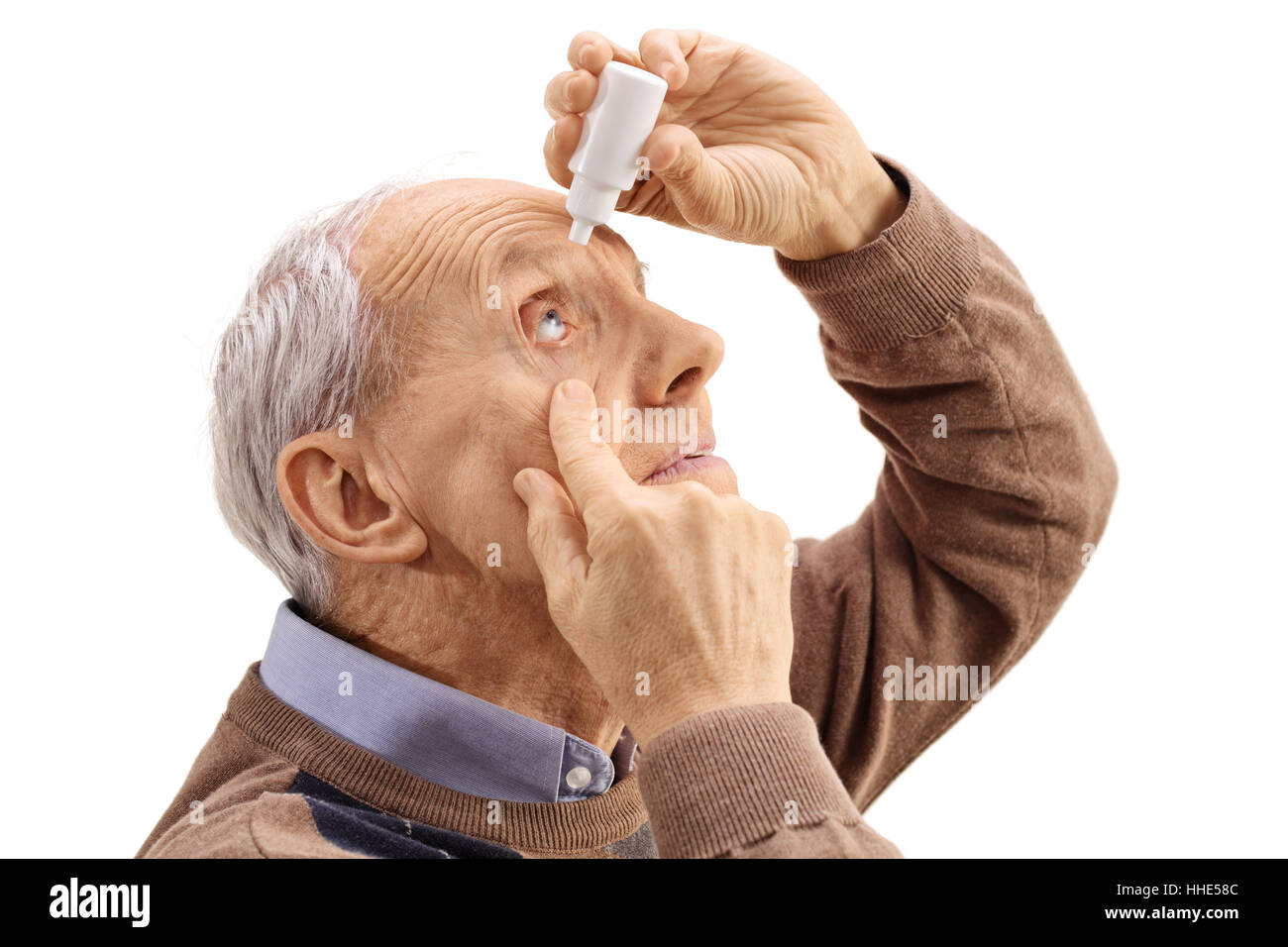 Elderly man applying eye drops isolated on white background Stock Photo ...