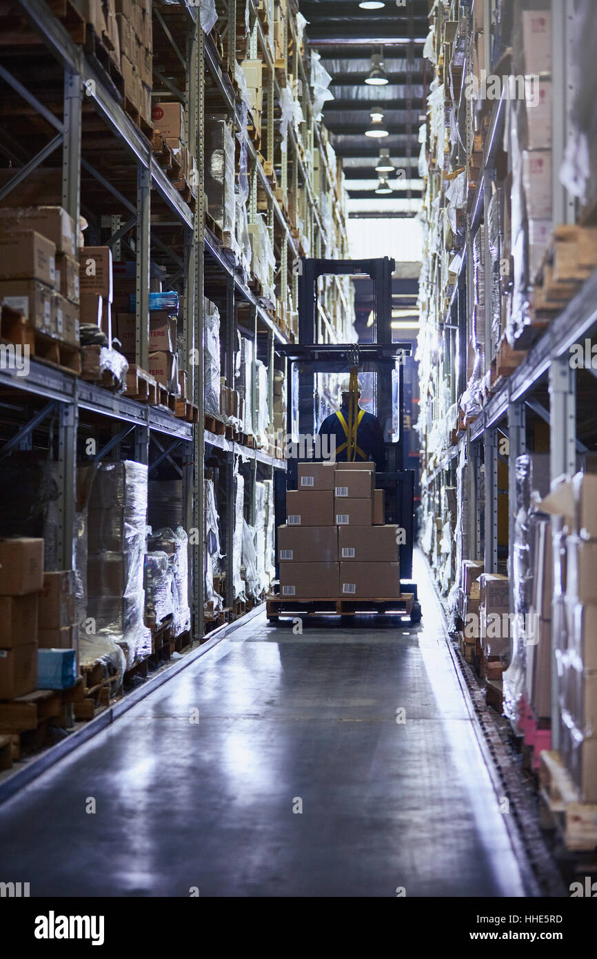 Forklift driving in warehouse aisle hi-res stock photography and images ...