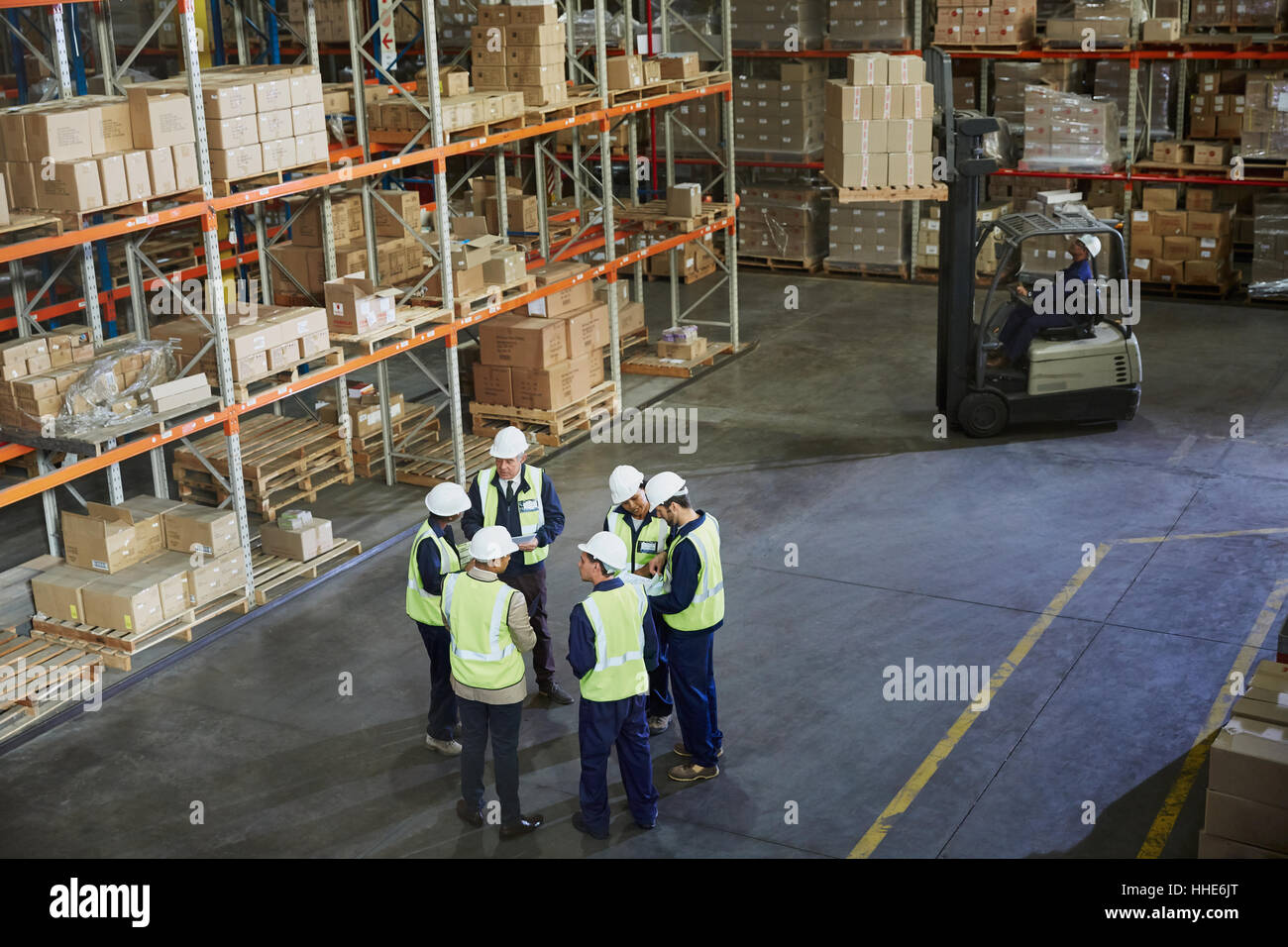 Workers meeting in a circle in distribution warehouse Stock Photo - Alamy