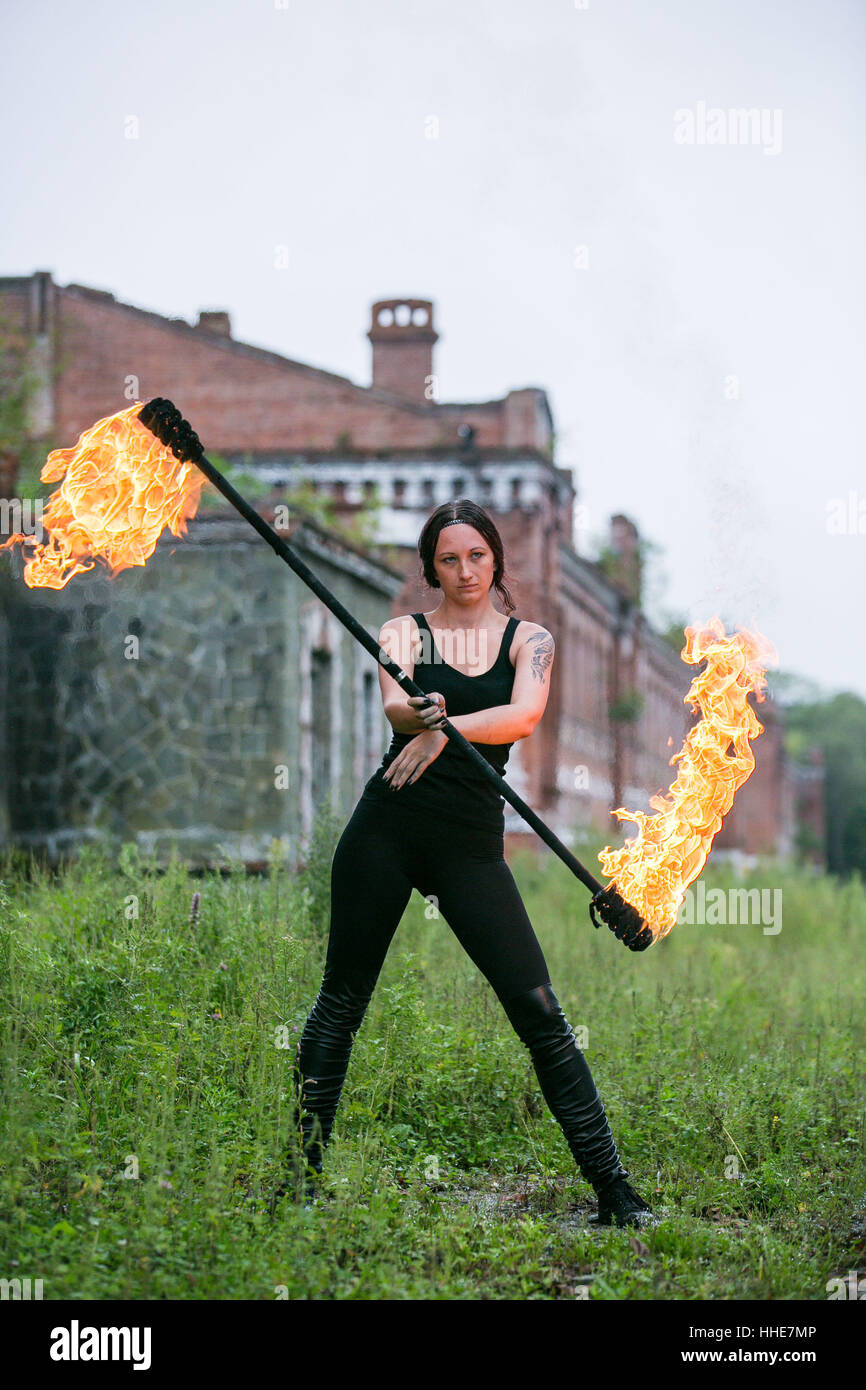 Fire show girl with flaming torches Stock Photo - Alamy