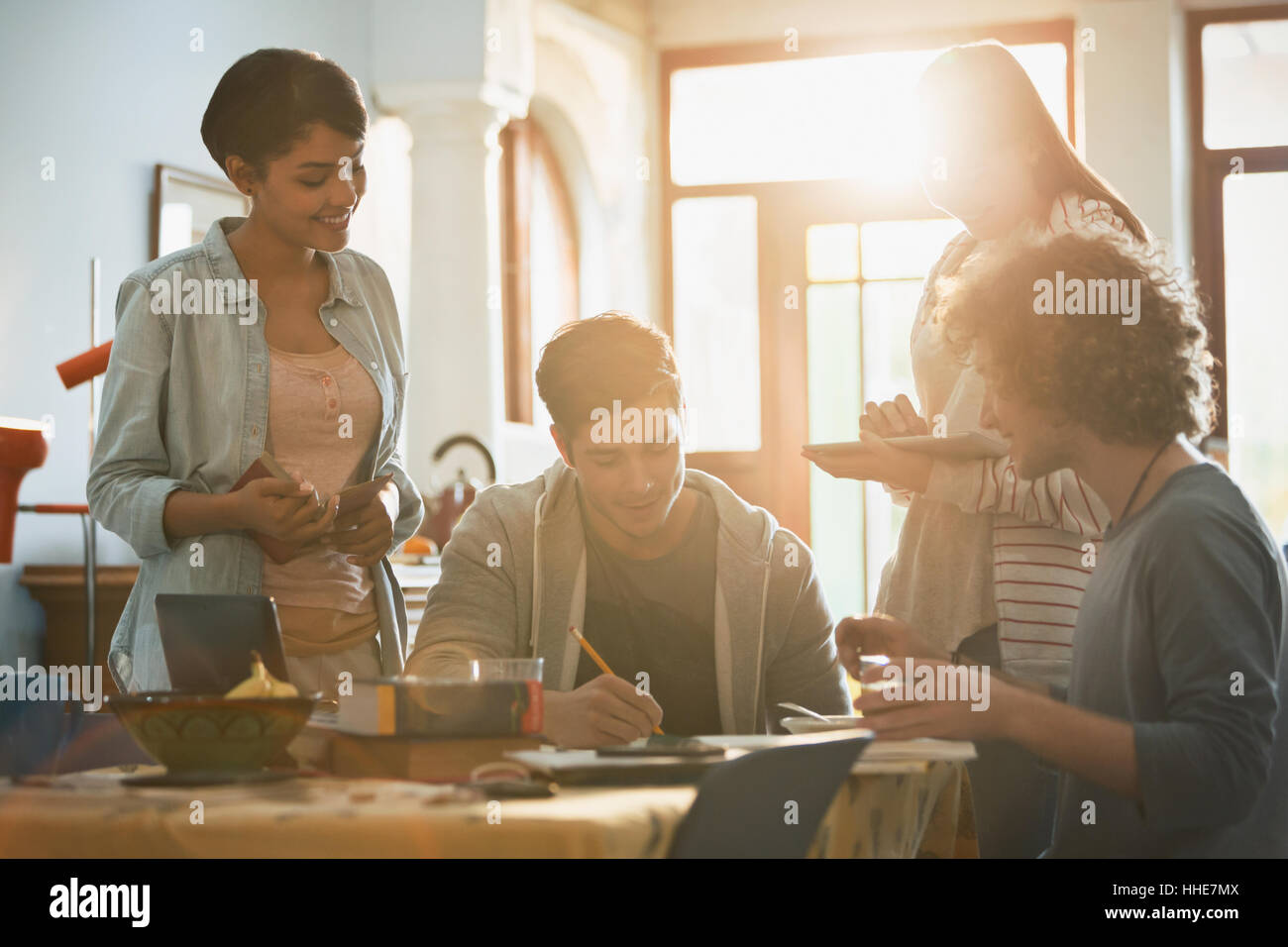 Young couples college students studying at table Stock Photo - Alamy