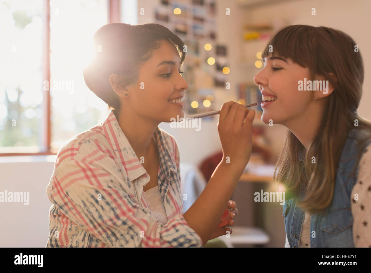 Young women friends applying makeup Stock Photo - Alamy