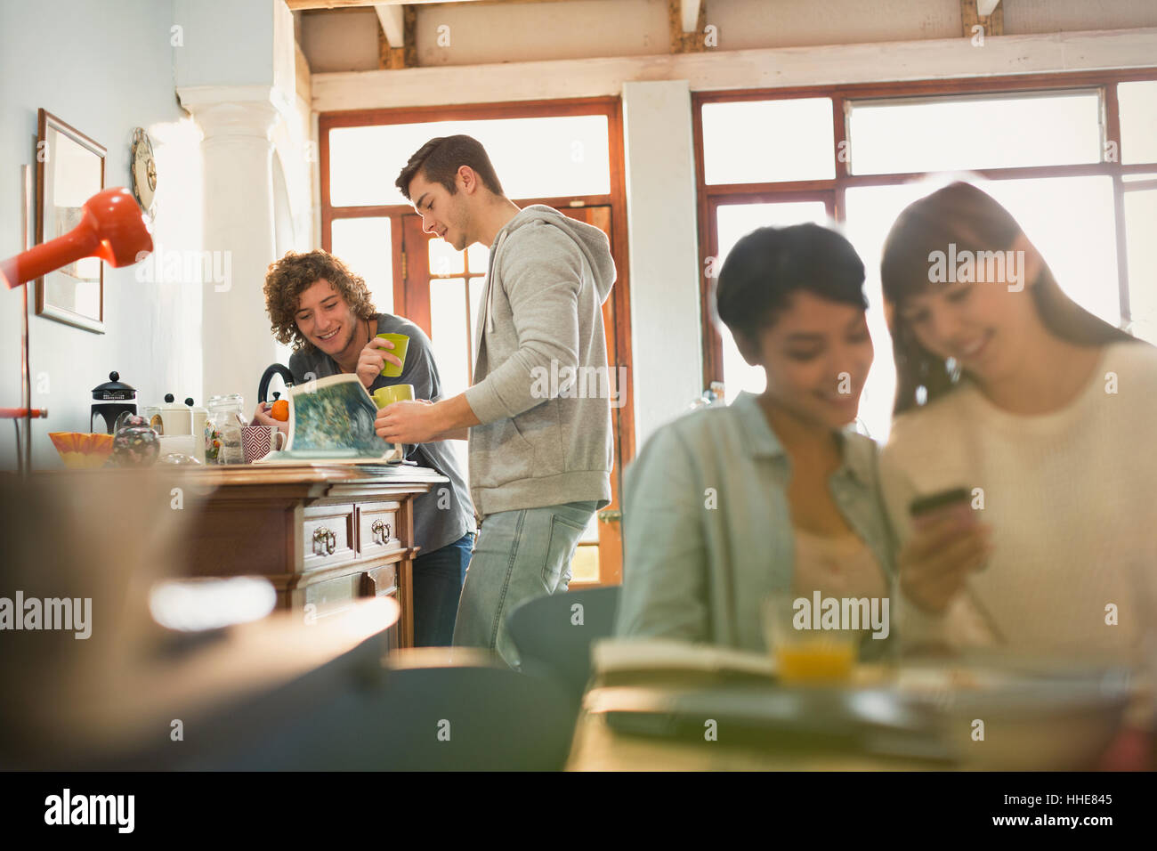 Young friend roommates hanging out in apartment Stock Photo - Alamy