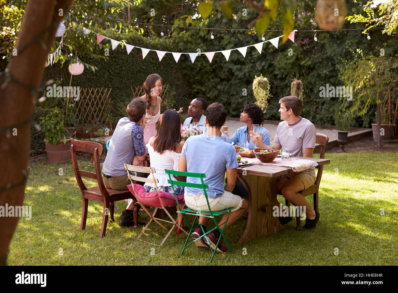 Woman Serving Food To Friends At Outdoor Backyard Party Stock Photo - Alamy