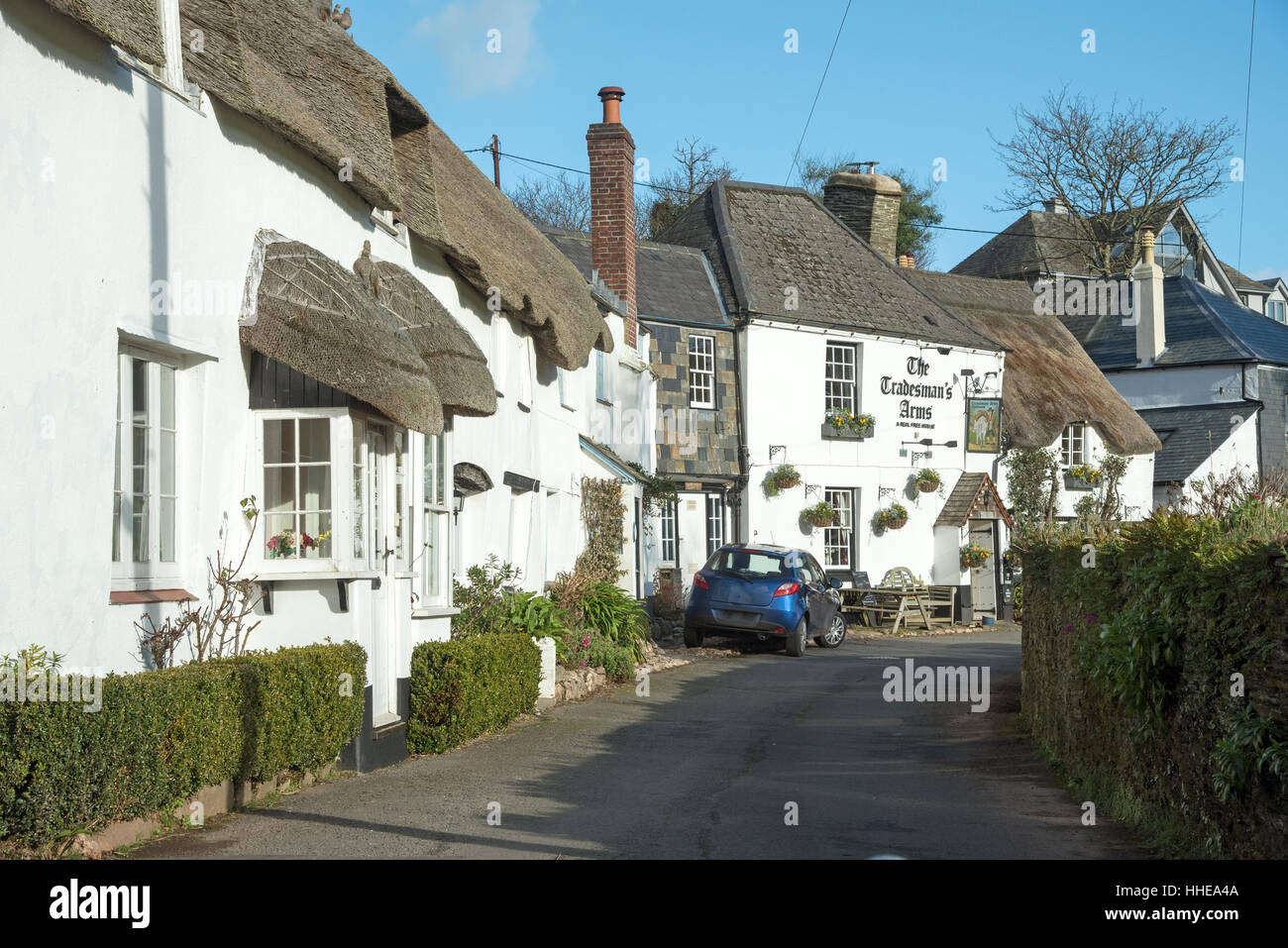 A narrow country lane with homes and a public house at Stokenham South ...