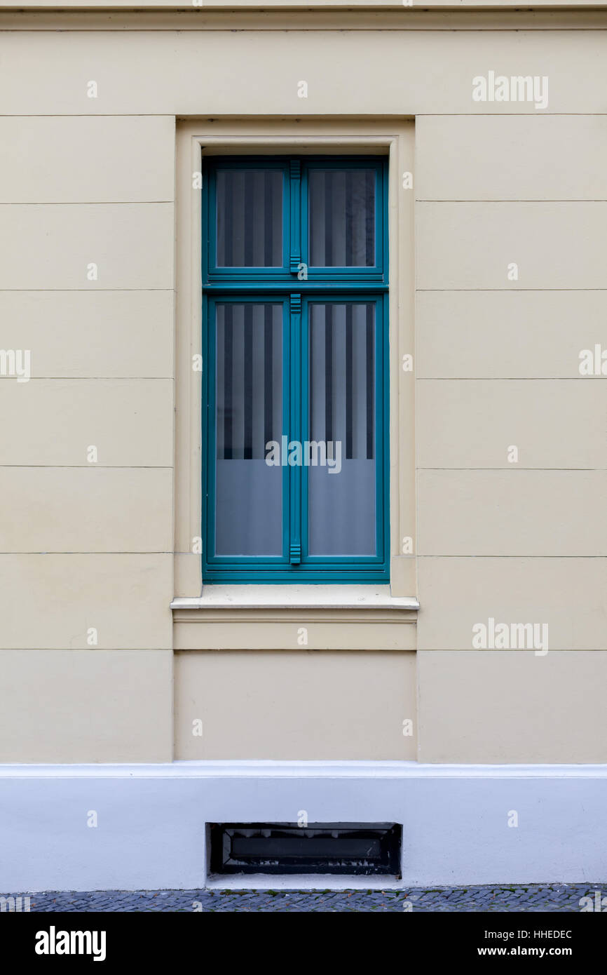 A small blue rectangular window on a cream-colored wall Stock Photo - Alamy