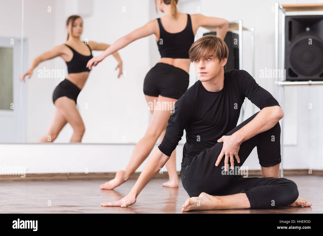 Confident persistent man sitting on the floor Stock Photo - Alamy