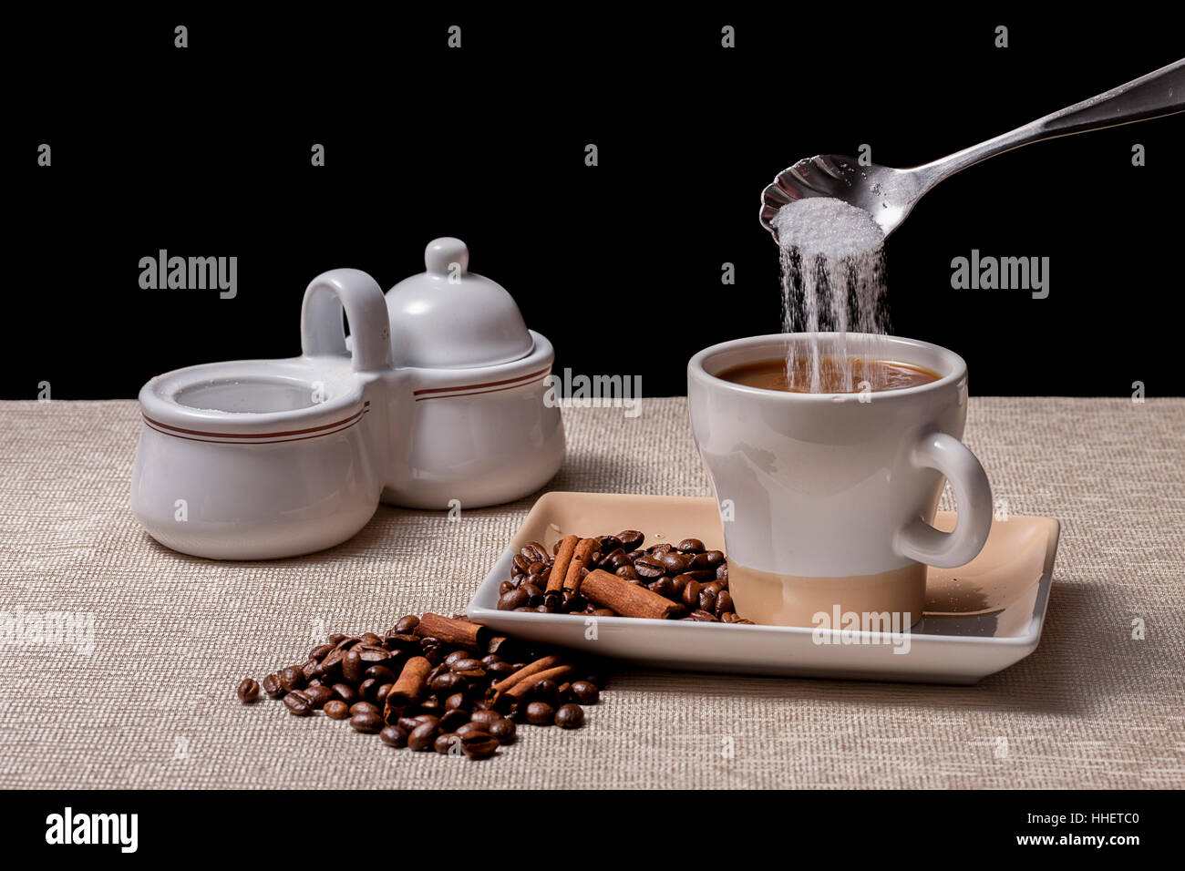 Sugar being poured into coffee Stock Photo - Alamy