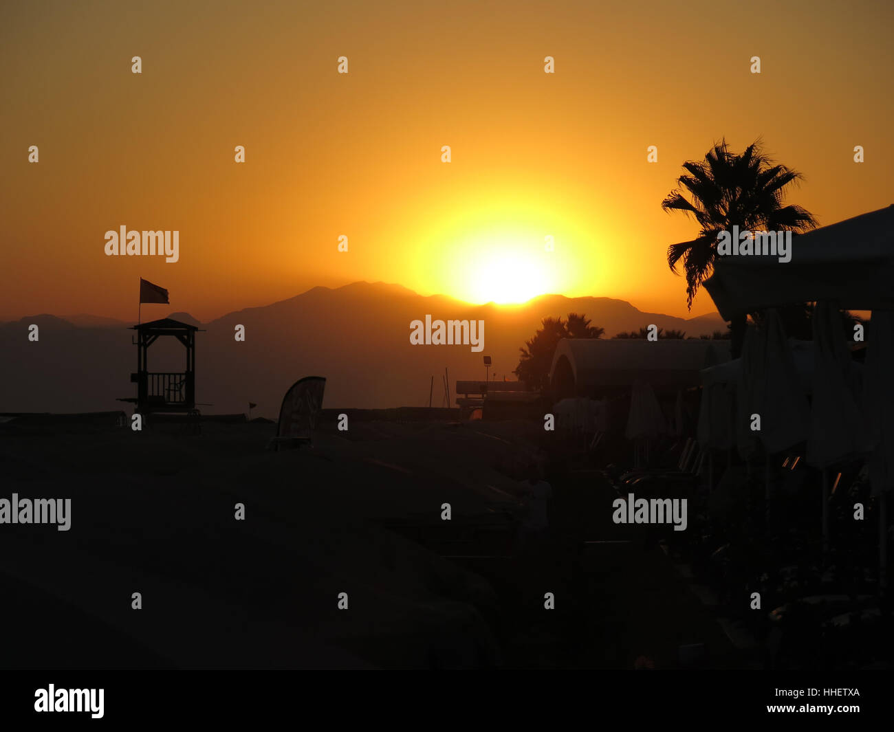 A sunset at a beach in Southern Turkey with palm tree and other shadows ...