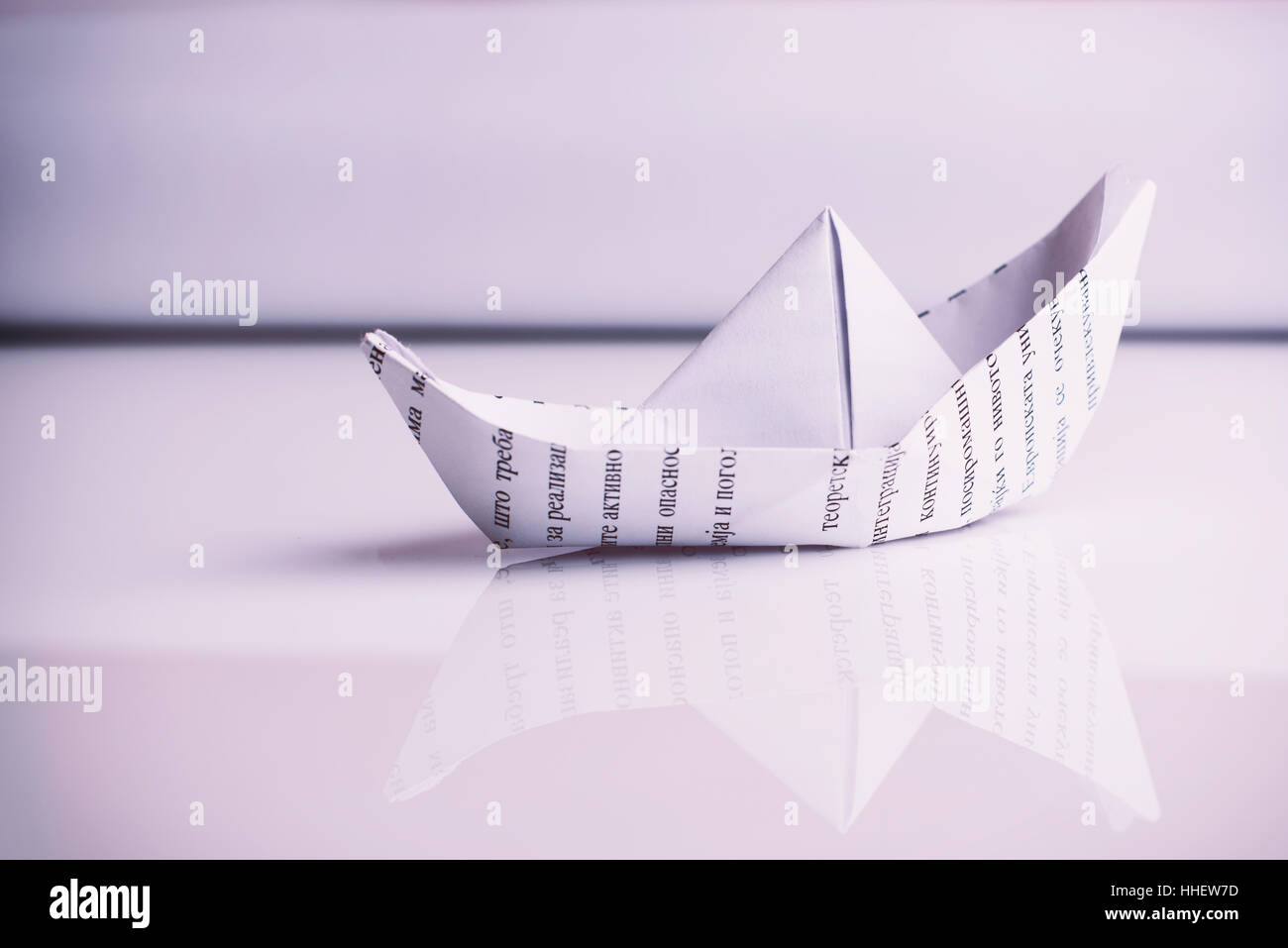 Paper boat sails, on white background Stock Photo - Alamy