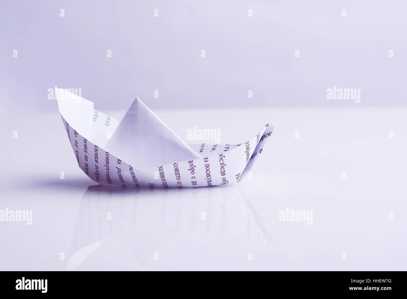 Paper boat sails, on white background Stock Photo - Alamy