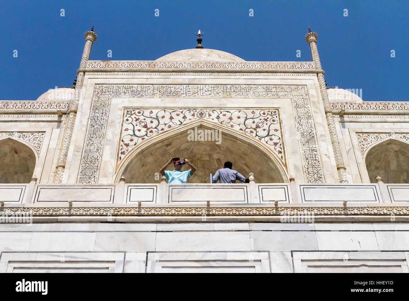 Tourists on the terrace of the Taj Mahal underneath the central dome ...