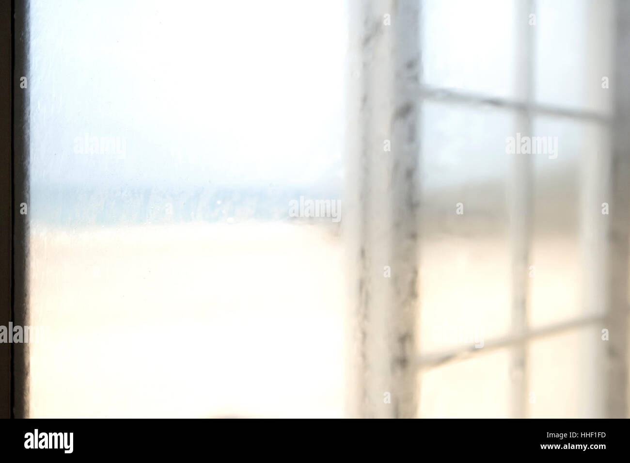 Window out of focus looking out towards the beach Stock Photo - Alamy