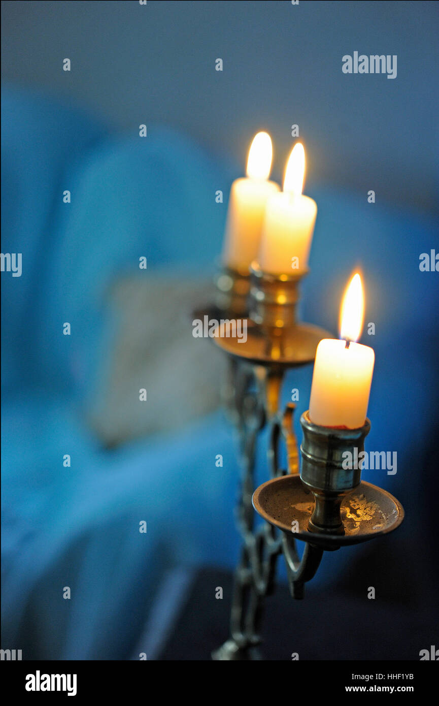 Three Candles alight in sitting room Stock Photo - Alamy