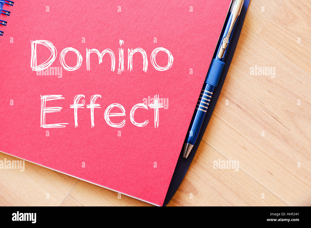 Domino effect text concept write on notebook Stock Photo - Alamy
