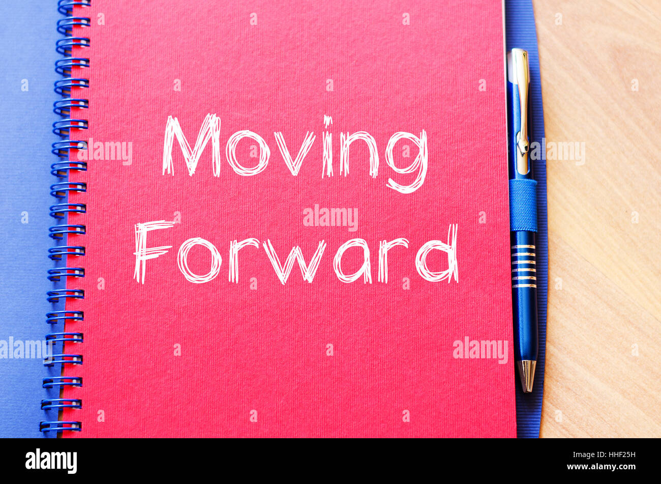 Moving forward text concept write on notebook Stock Photo - Alamy