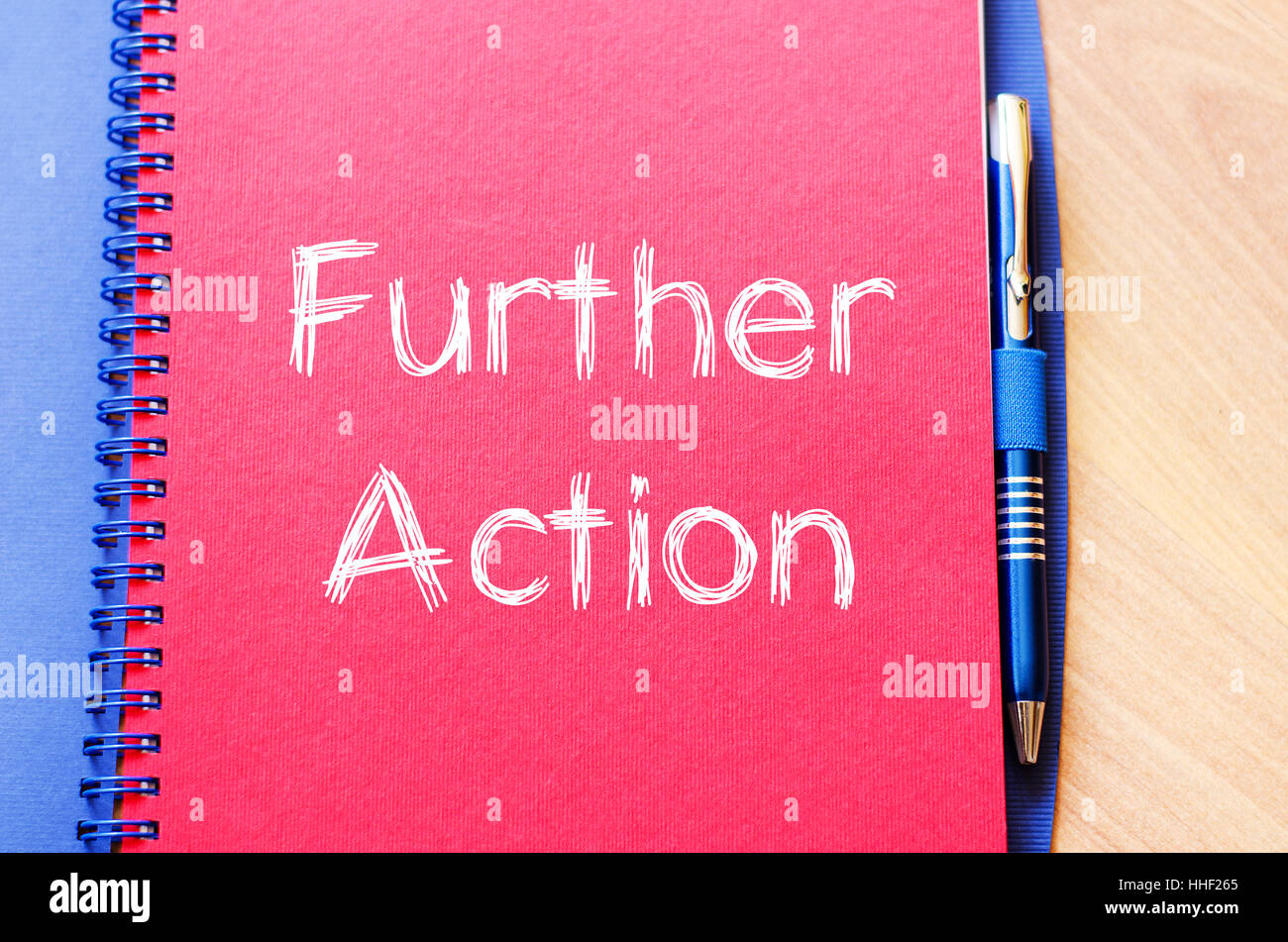Further action text concept write on notebook Stock Photo - Alamy