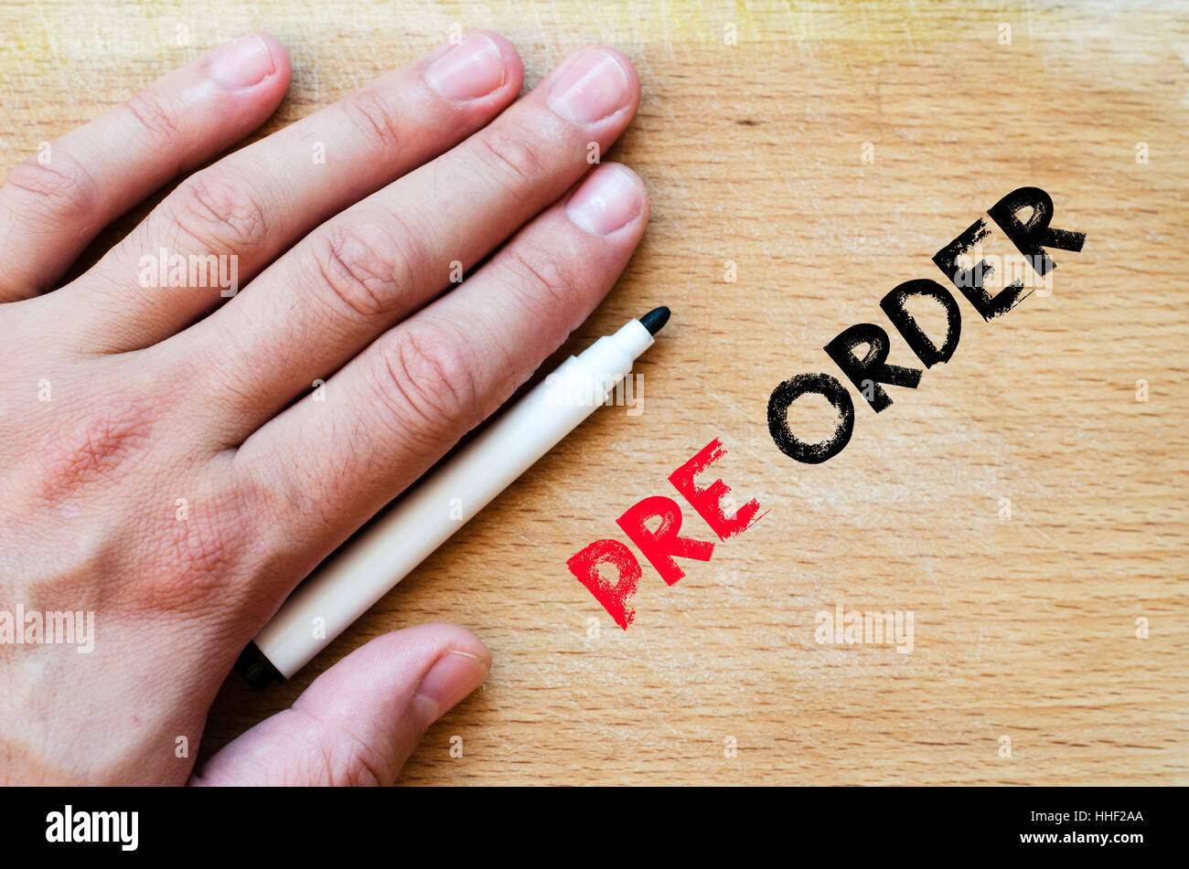 Human hand over wooden background and pre order text concept Stock ...