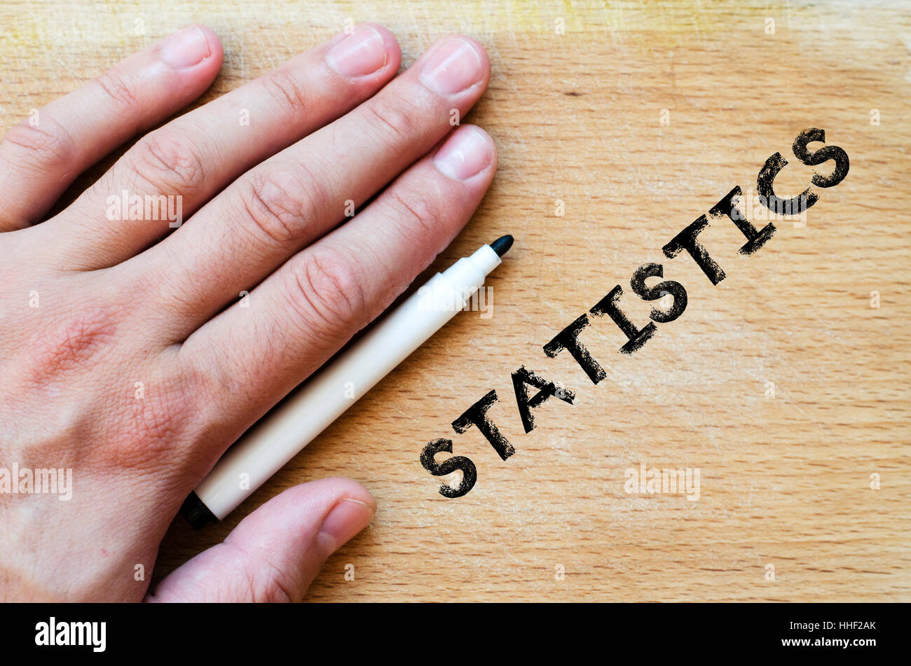 Human hand over wooden background and statistics text concept Stock ...