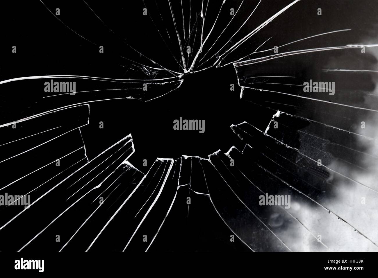 Broken glass hole with black background Stock Photo - Alamy