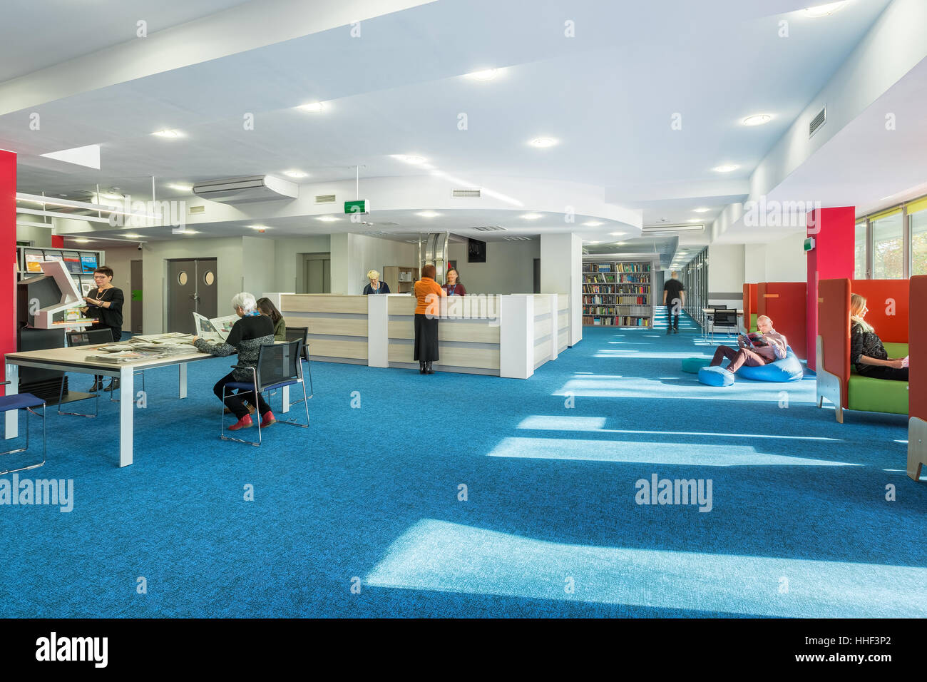 Modern and spacious university library with blue carpet on the floor ...