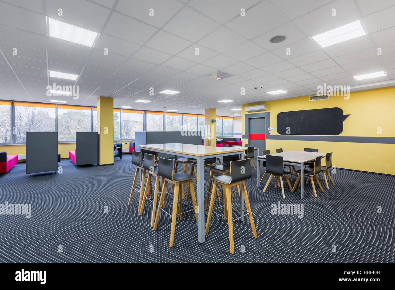 Bright library interior with high tables and stools Stock Photo - Alamy