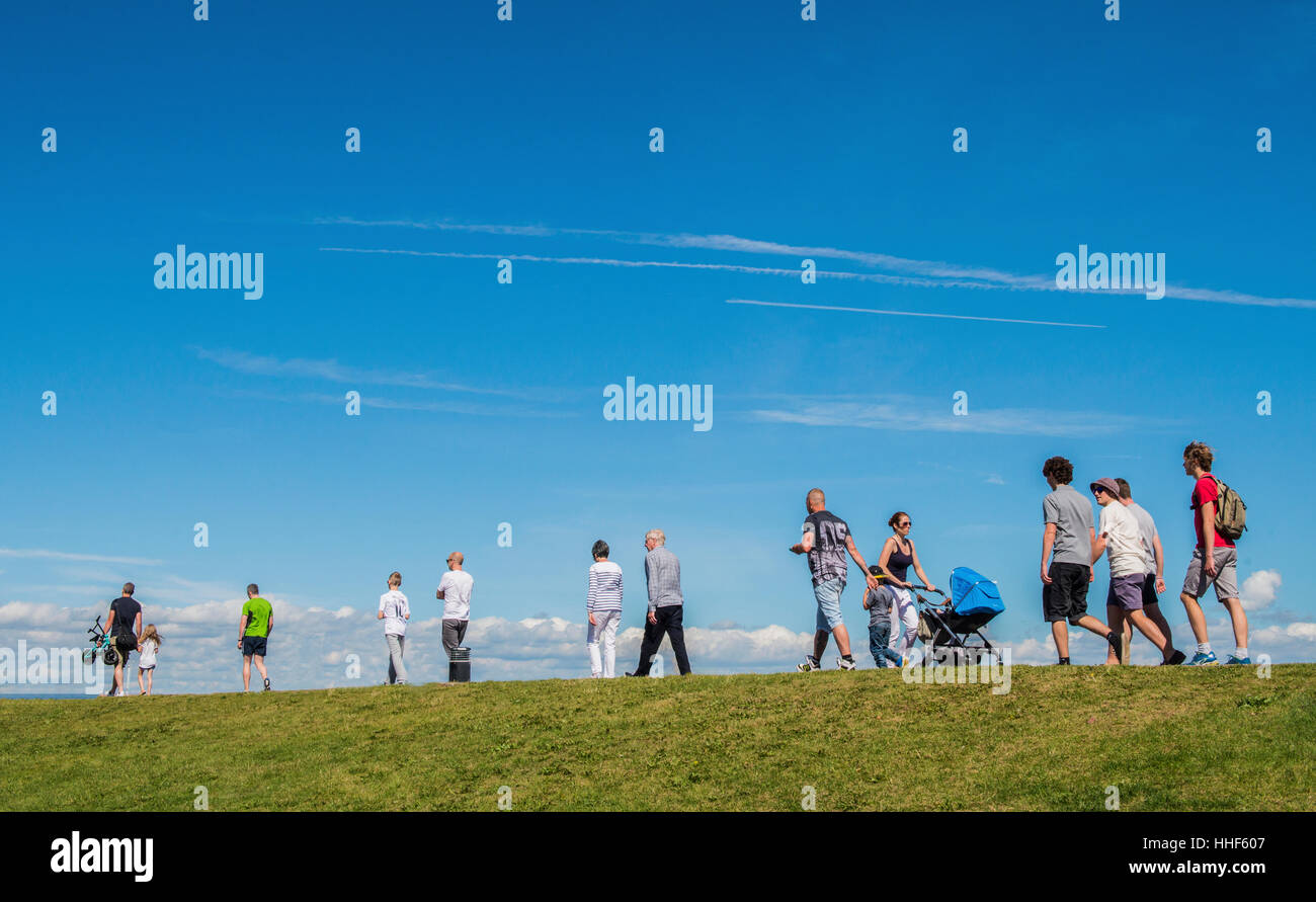 A string of people walking across the Cardiff Bay Barrage and ...
