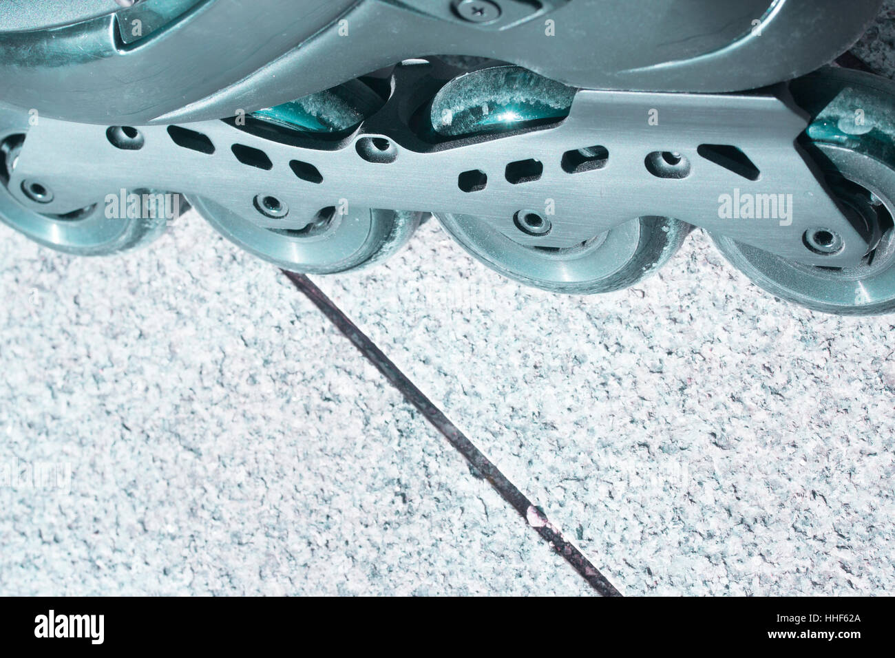 Inline freestyle roller blade skates in street on road surface skating ...